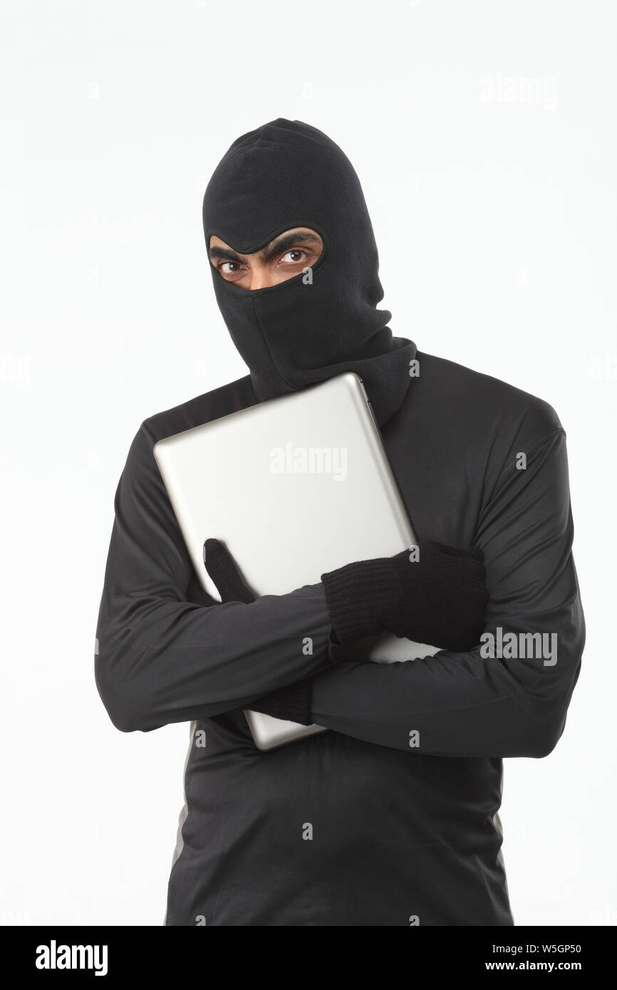Hacker holding a laptop Stock Photo - Alamy