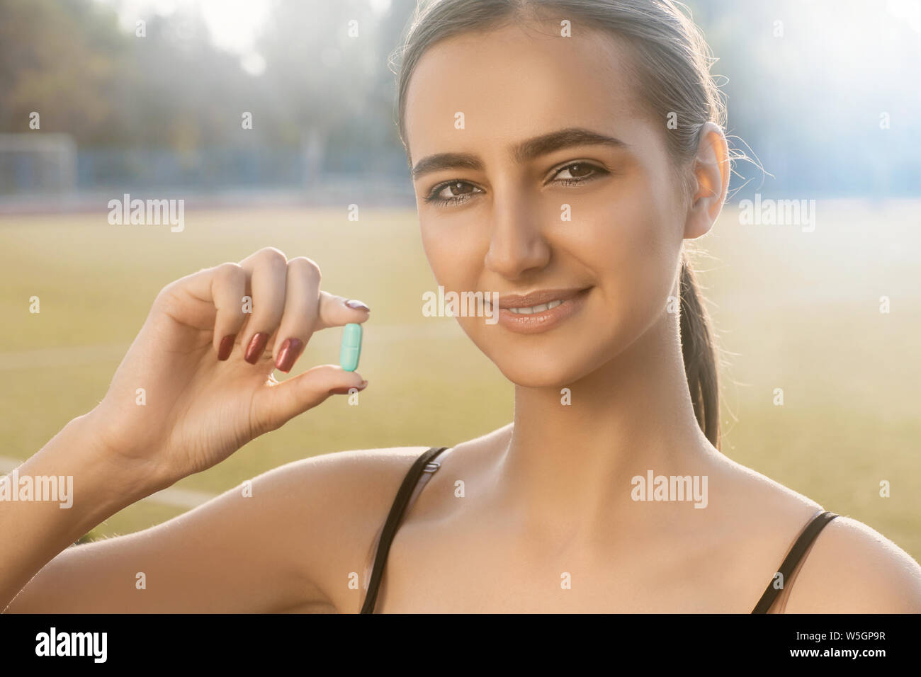 Woman taking supplements happy hi-res stock photography and images - Alamy