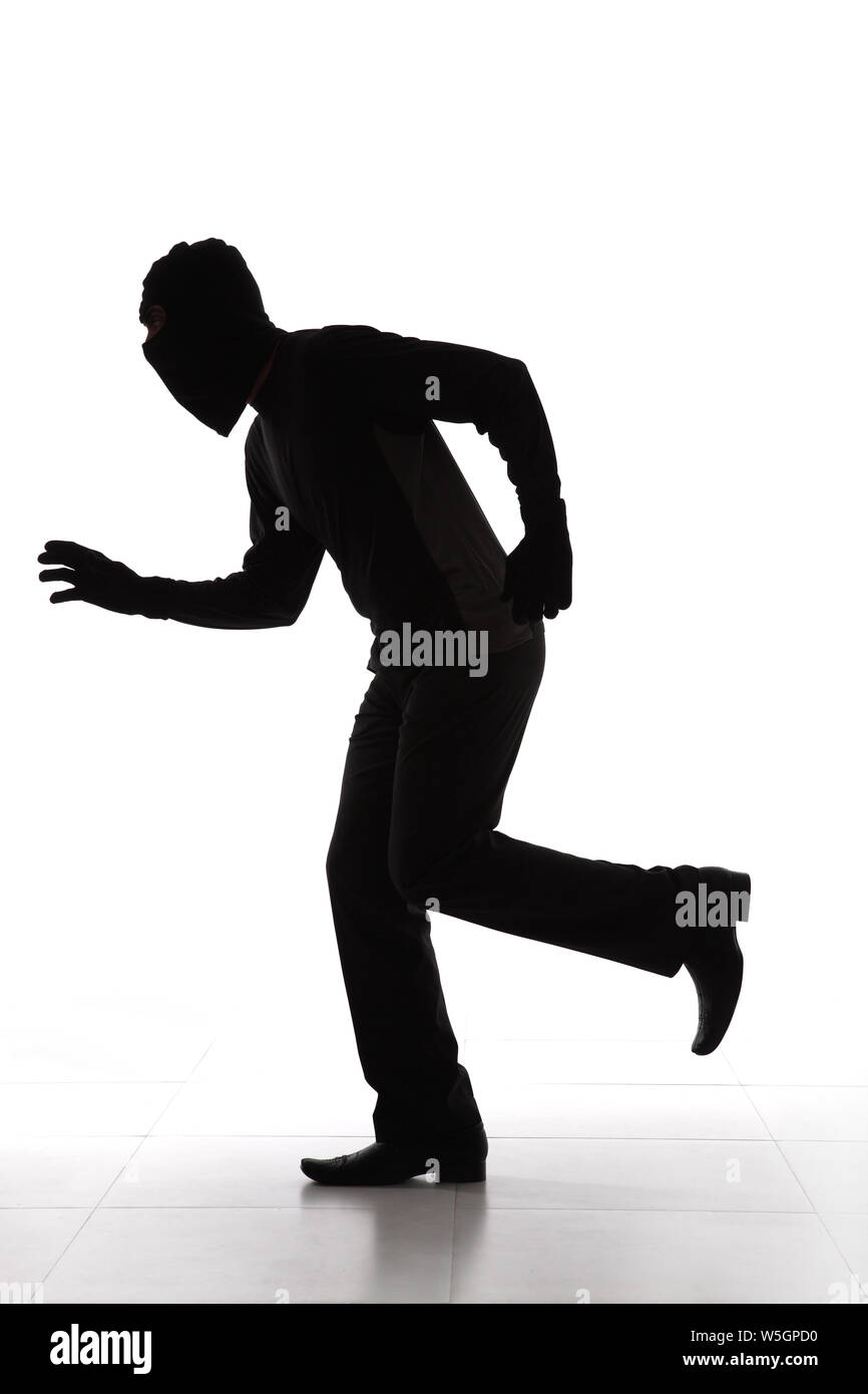 Silhouette of a thief running Stock Photo - Alamy