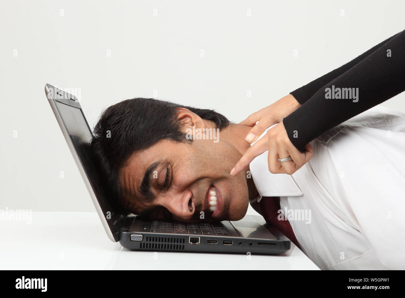 Manager pushing office worker face against laptop keyboard Stock Photo ...