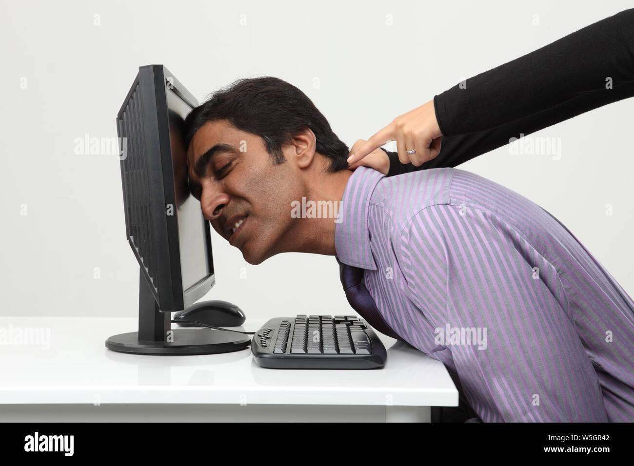 Manager pushing office worker face against computer screen Stock Photo ...