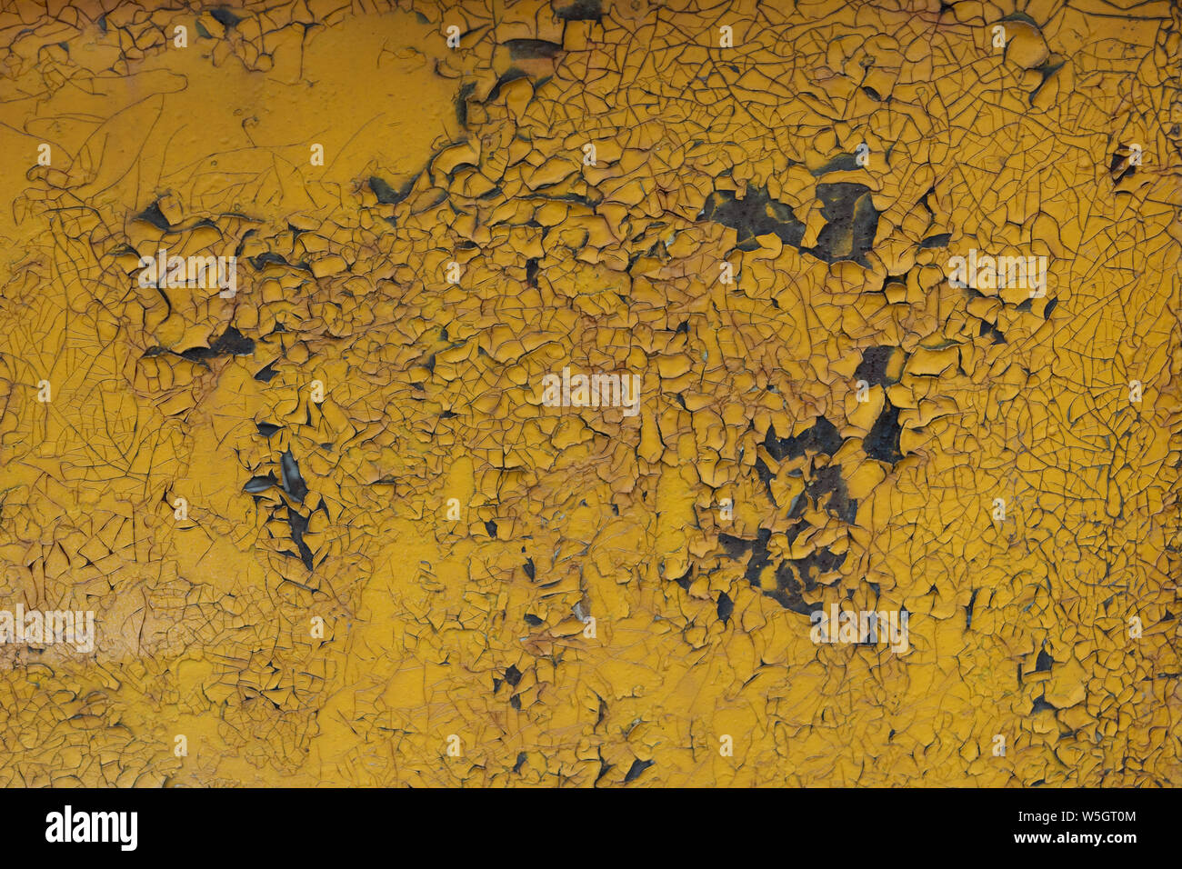 Old yellow cracked paint background. Grunge texture template for ...