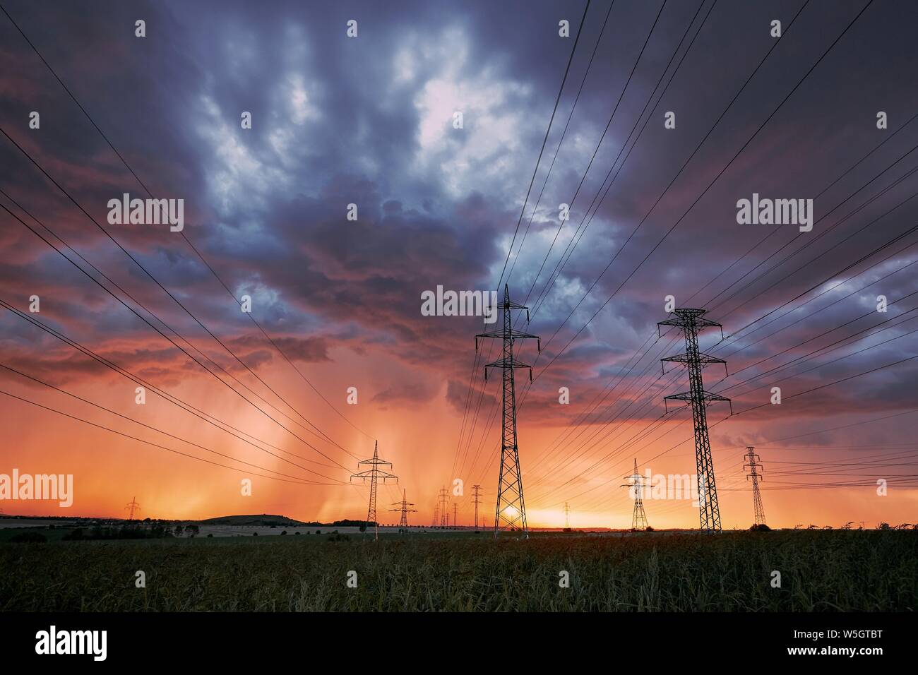 Extreme weather. Electricity pylons with power lines against stunning ...