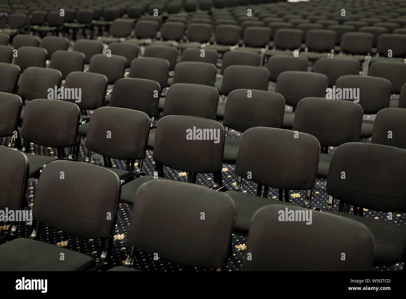 Black chairs in big empty congress room before start Stock Photo - Alamy