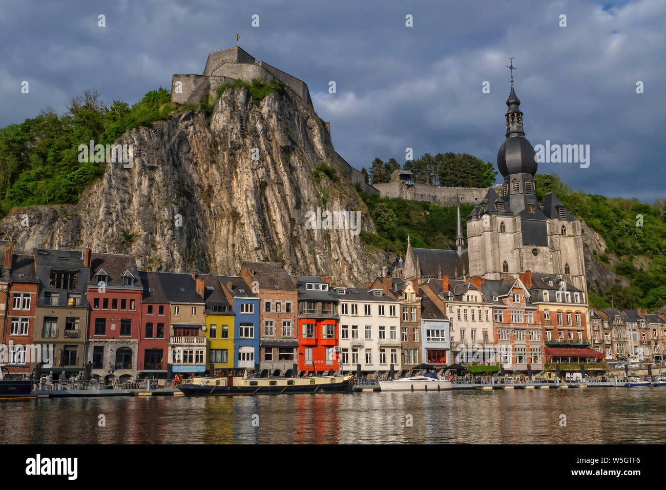 Colorful Dinant town view with its citadel and church by sunset ...