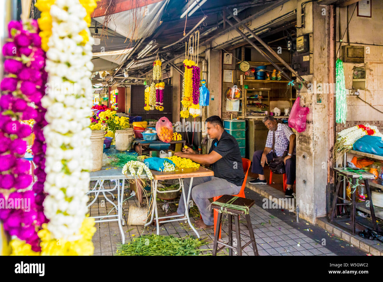 Colourful traditional garland maker in George Town, UNESCO World ...