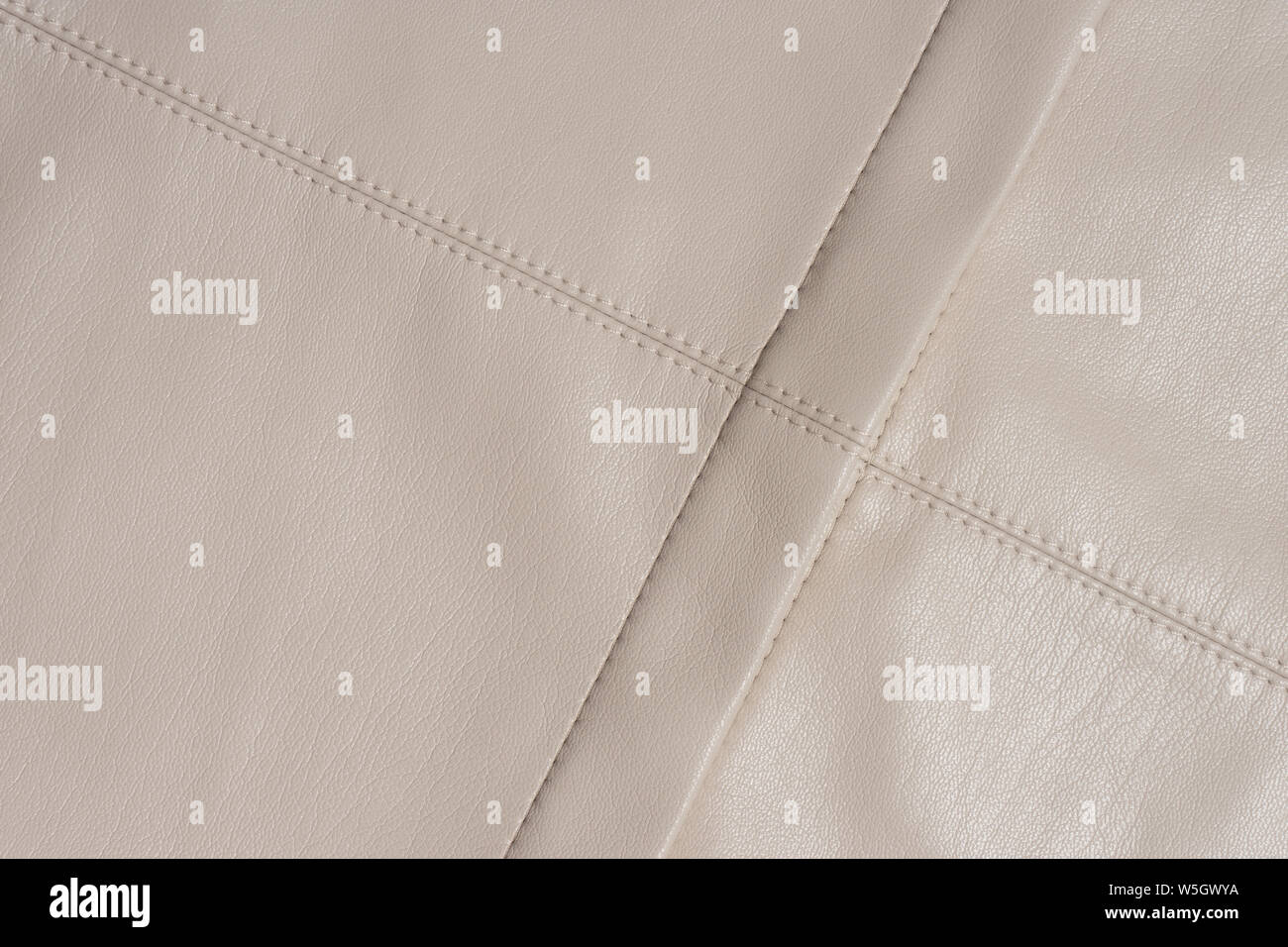 Beige leather stitched surface. Diagonal lines with copy space ...