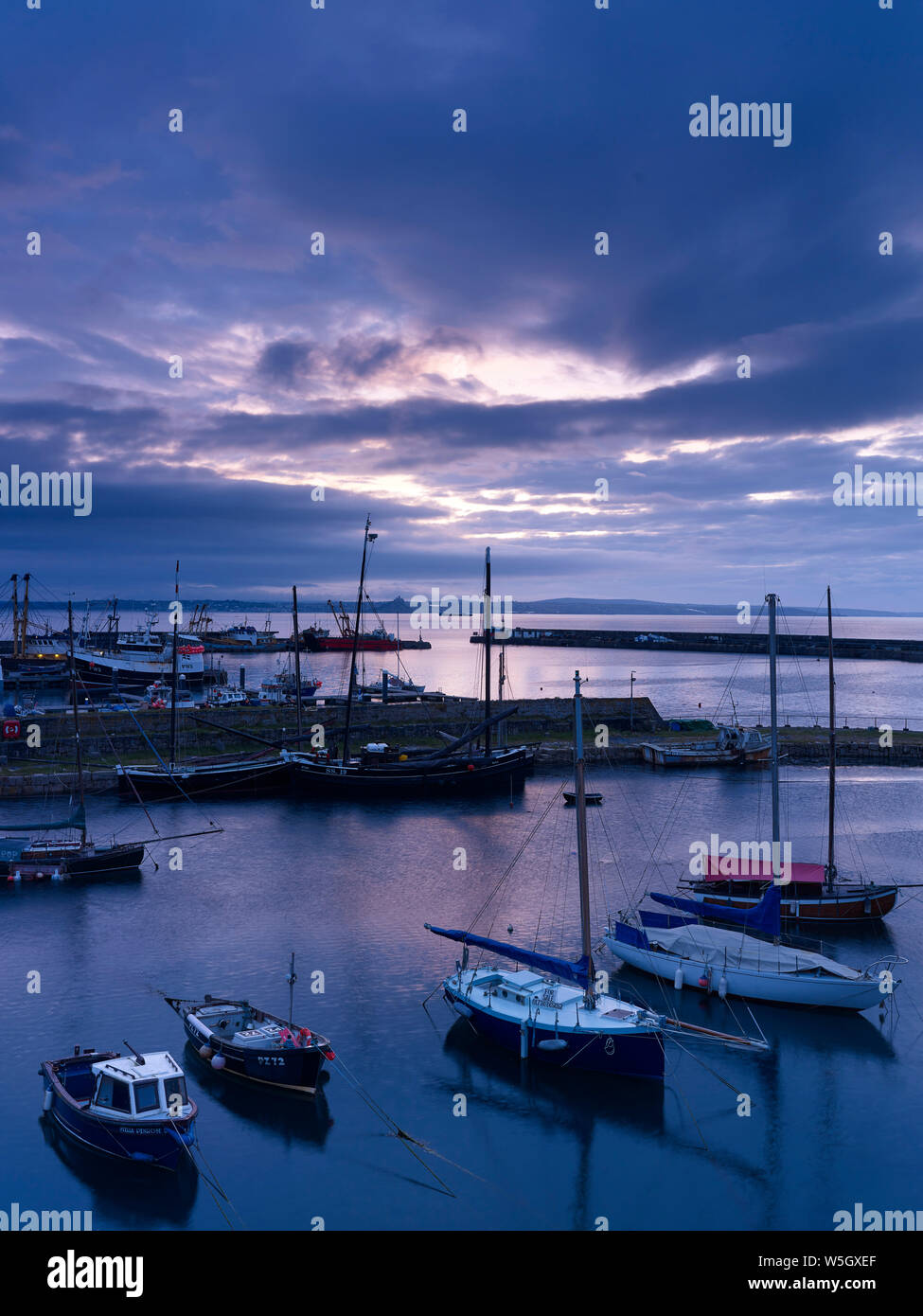 Spring twilight across the harbour at the fishing port of Newlyn ...