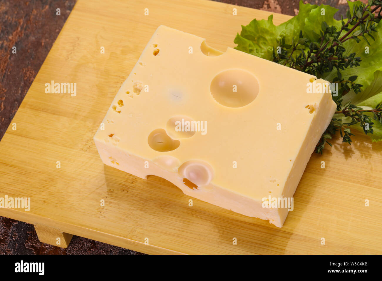 Maasdam cheese brick with thyme branch Stock Photo - Alamy
