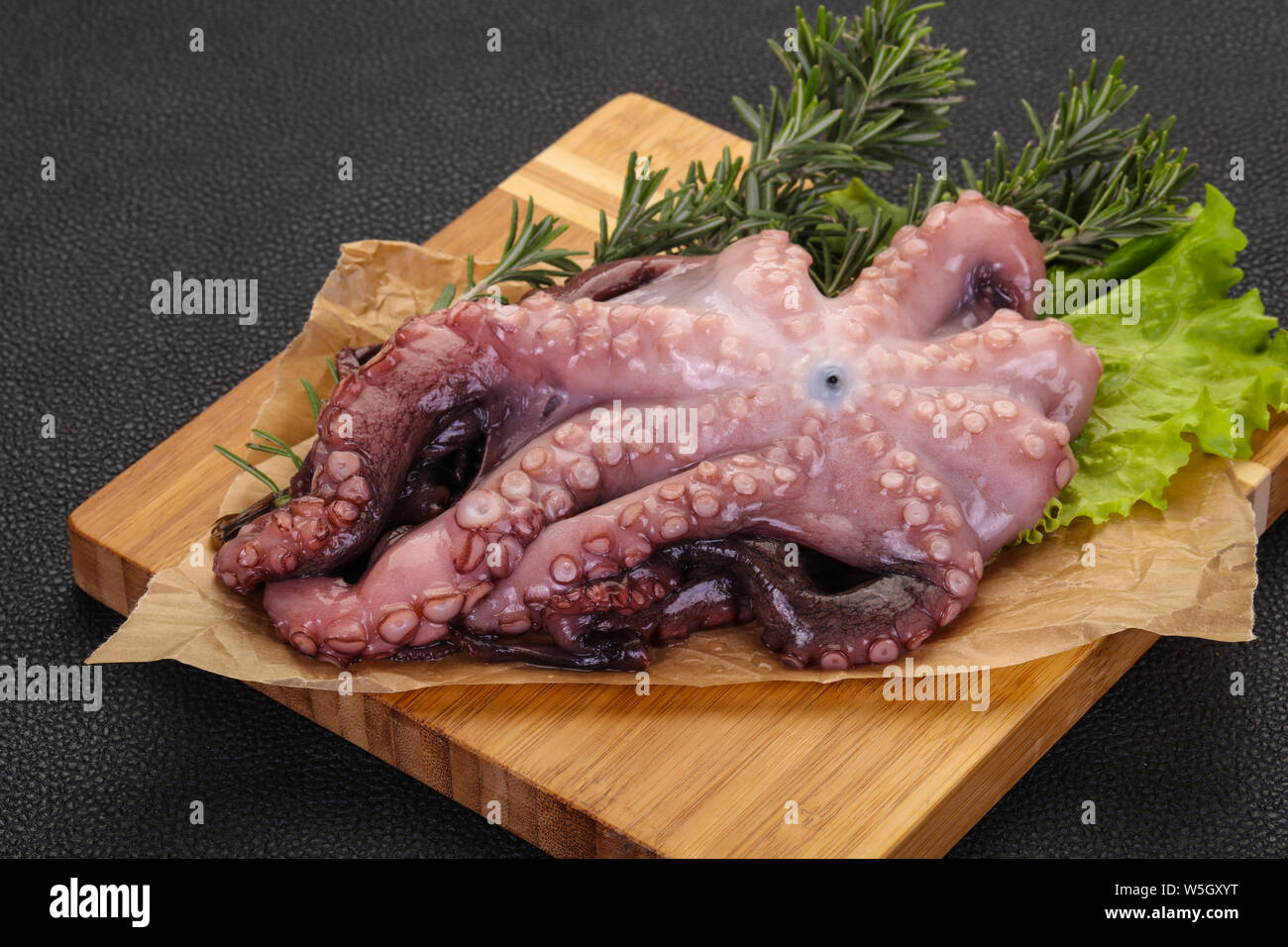 Raw octopus ready for cooking with rosemary Stock Photo - Alamy
