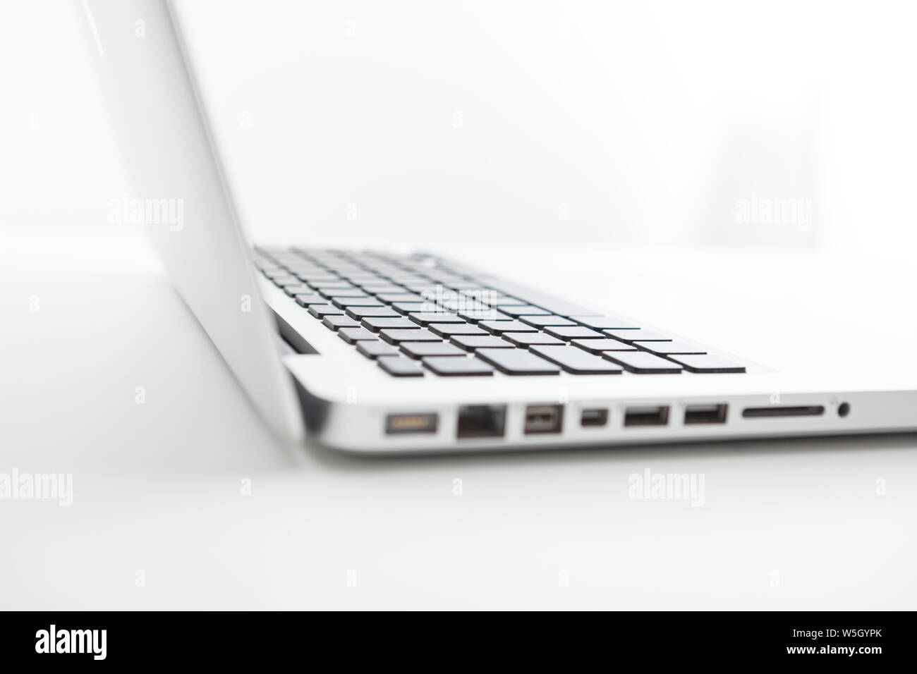 Left side view of Laptop isolated on white background, Aluminum body ...