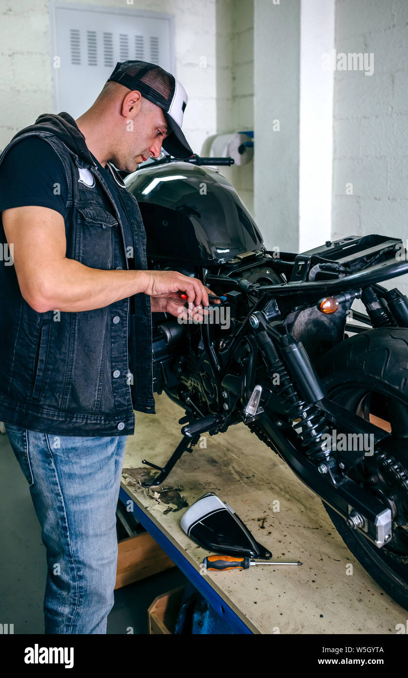 Motorcycle mechanic changing a fuse Stock Photo - Alamy
