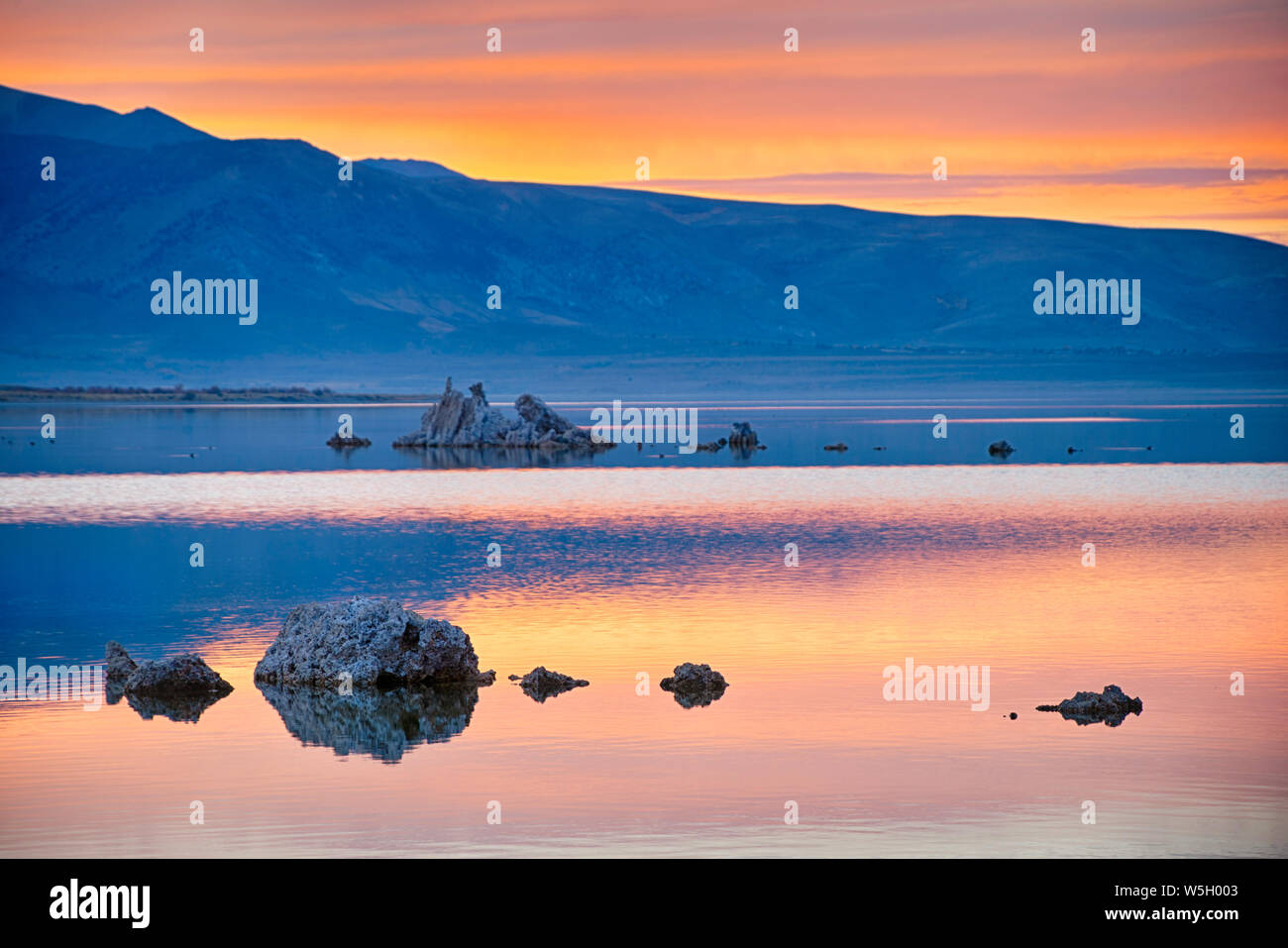 Ancient lake in a crater of an extinct volcano. Tufa stalactites are ...