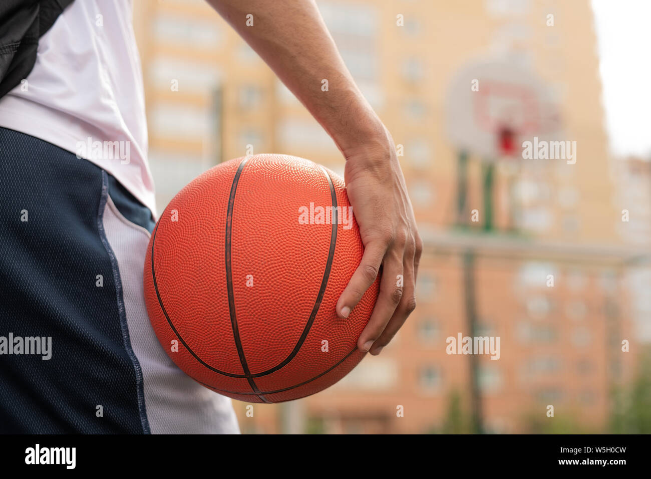 Hand of young professional basketball player holding ball Stock Photo ...