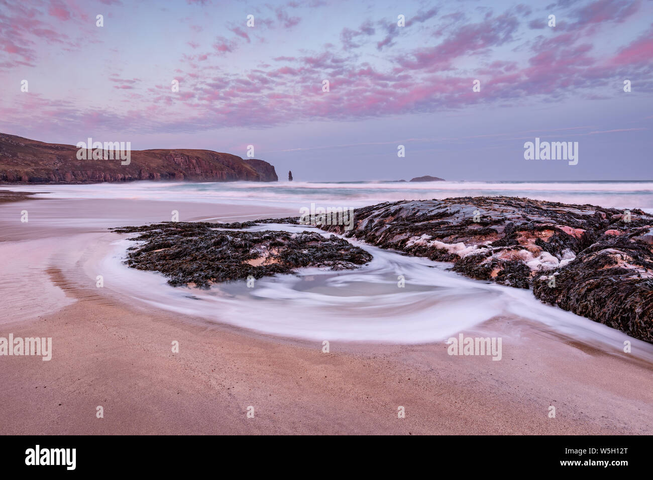Sandwood Bay at sunrise, with Am Buachaille sea stack in far distance ...