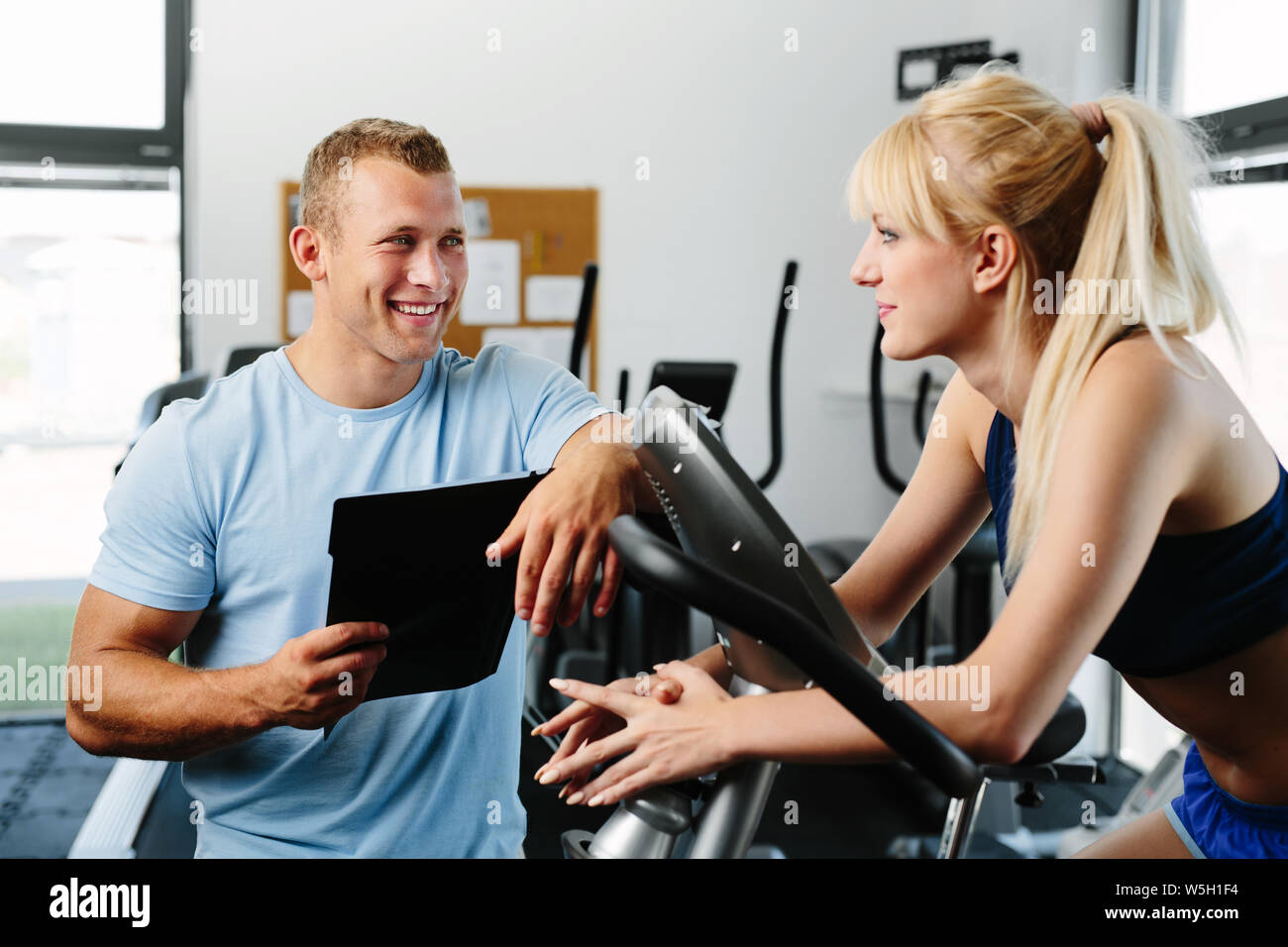 Woman and personal trainer talking hi-res stock photography and images ...