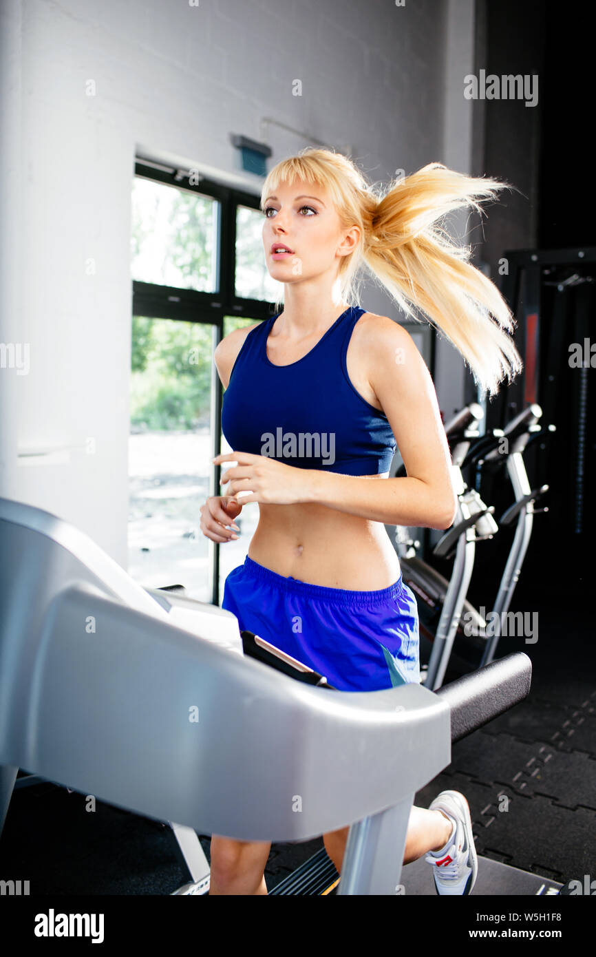 Photo of a female runner on a treadmill Stock Photo - Alamy