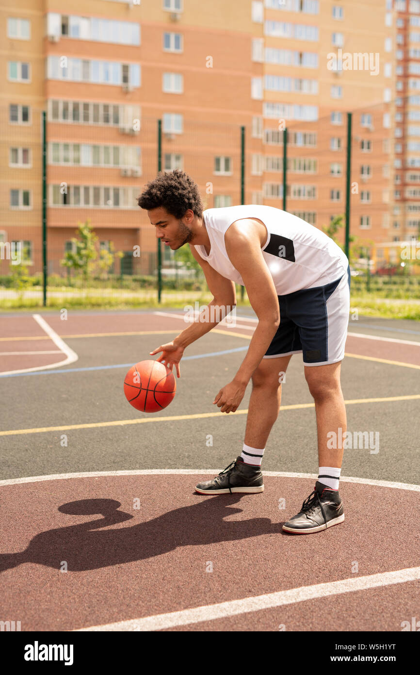 Young basketball player practicing exercise with ball Stock Photo - Alamy