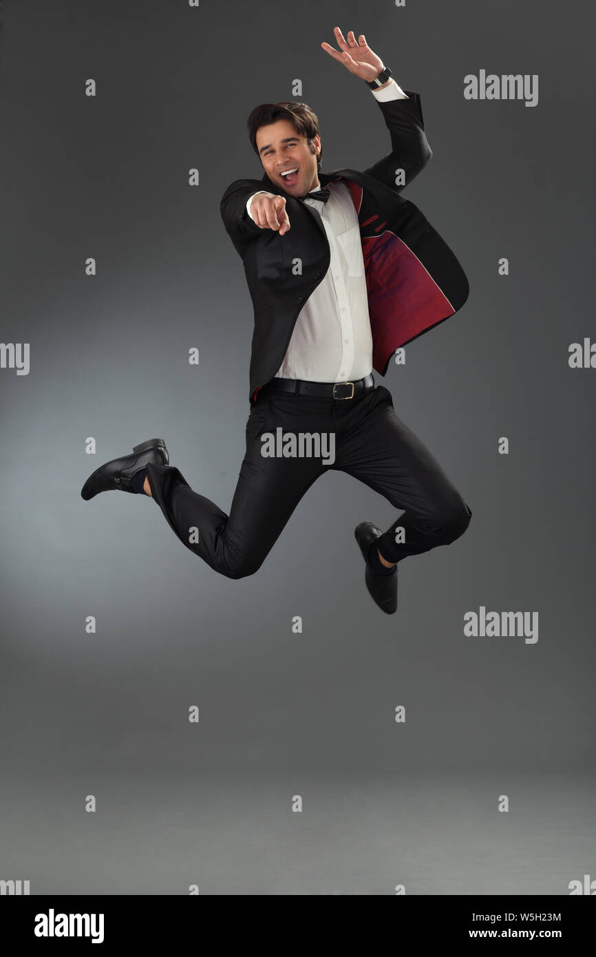 Man pointing and jumping Stock Photo - Alamy