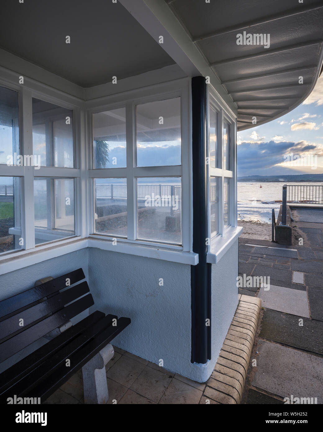 Late afternoon view through a shelter above steps to the beach, Exmouth ...