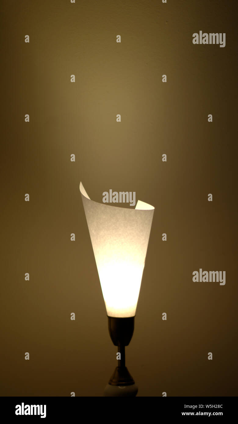 Warm light night lamp shining against a plain wall Stock Photo - Alamy