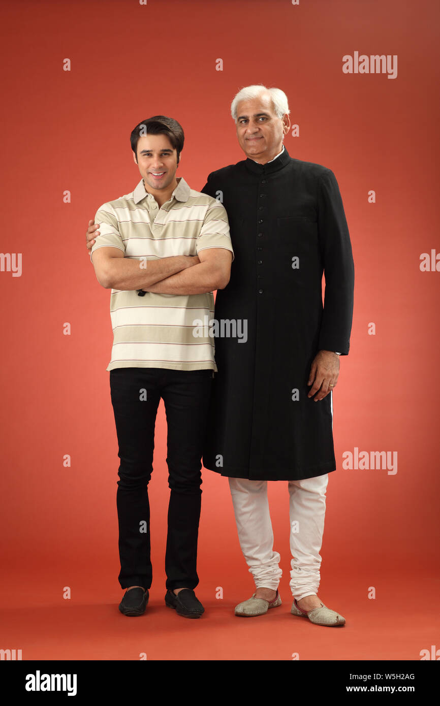 Old man with his son standing together Stock Photo - Alamy