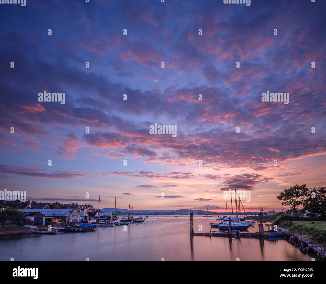 Sunset with boats on the Exe shoreline at the back of Camperdown ...