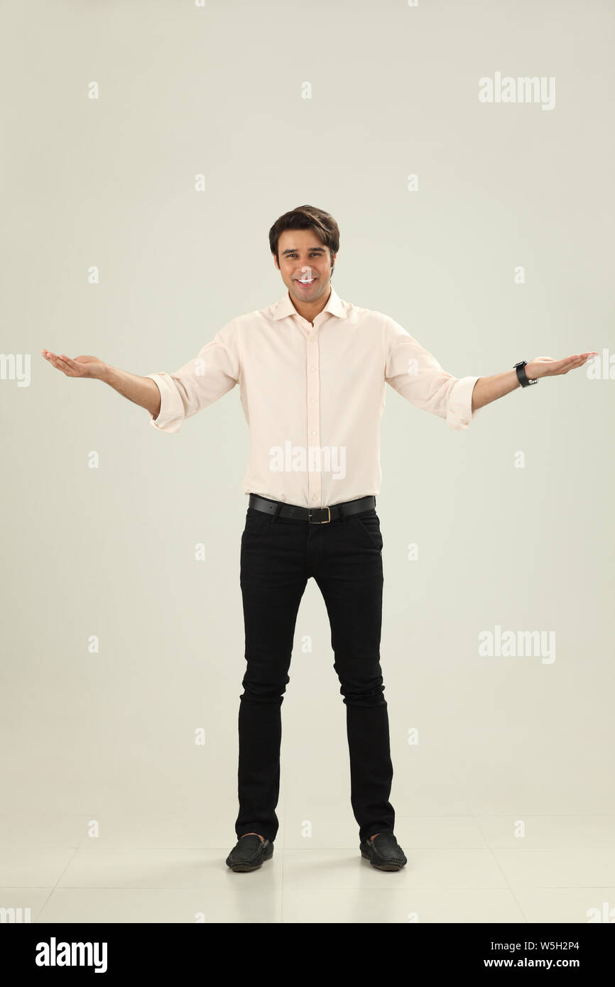 Man smiling with his arms outstretched Stock Photo - Alamy
