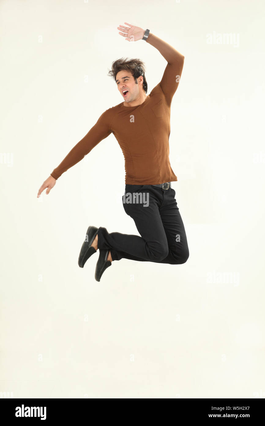 Man jumping in air and smiling Stock Photo - Alamy
