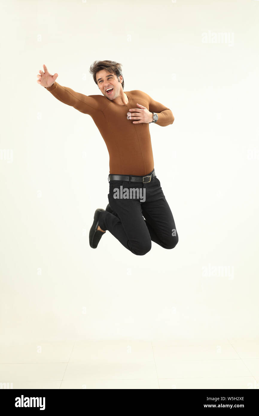 Man jumping in air and smiling Stock Photo - Alamy