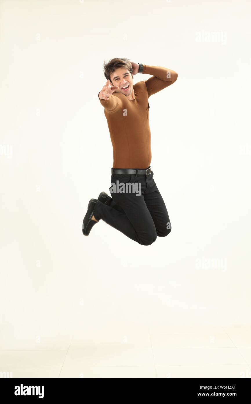 Man jumping in air and smiling Stock Photo - Alamy