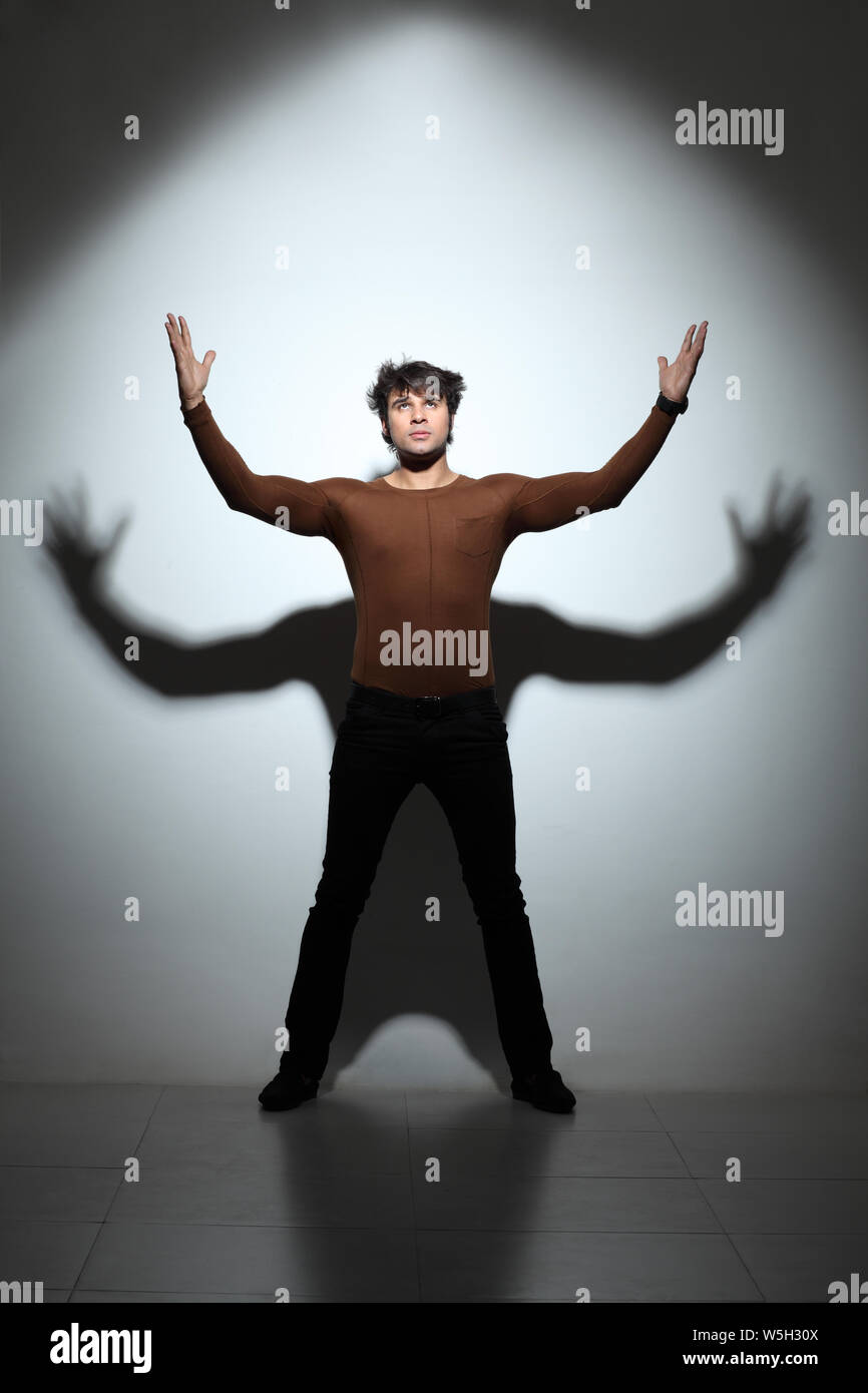 Man standing with arm outstretched Stock Photo - Alamy