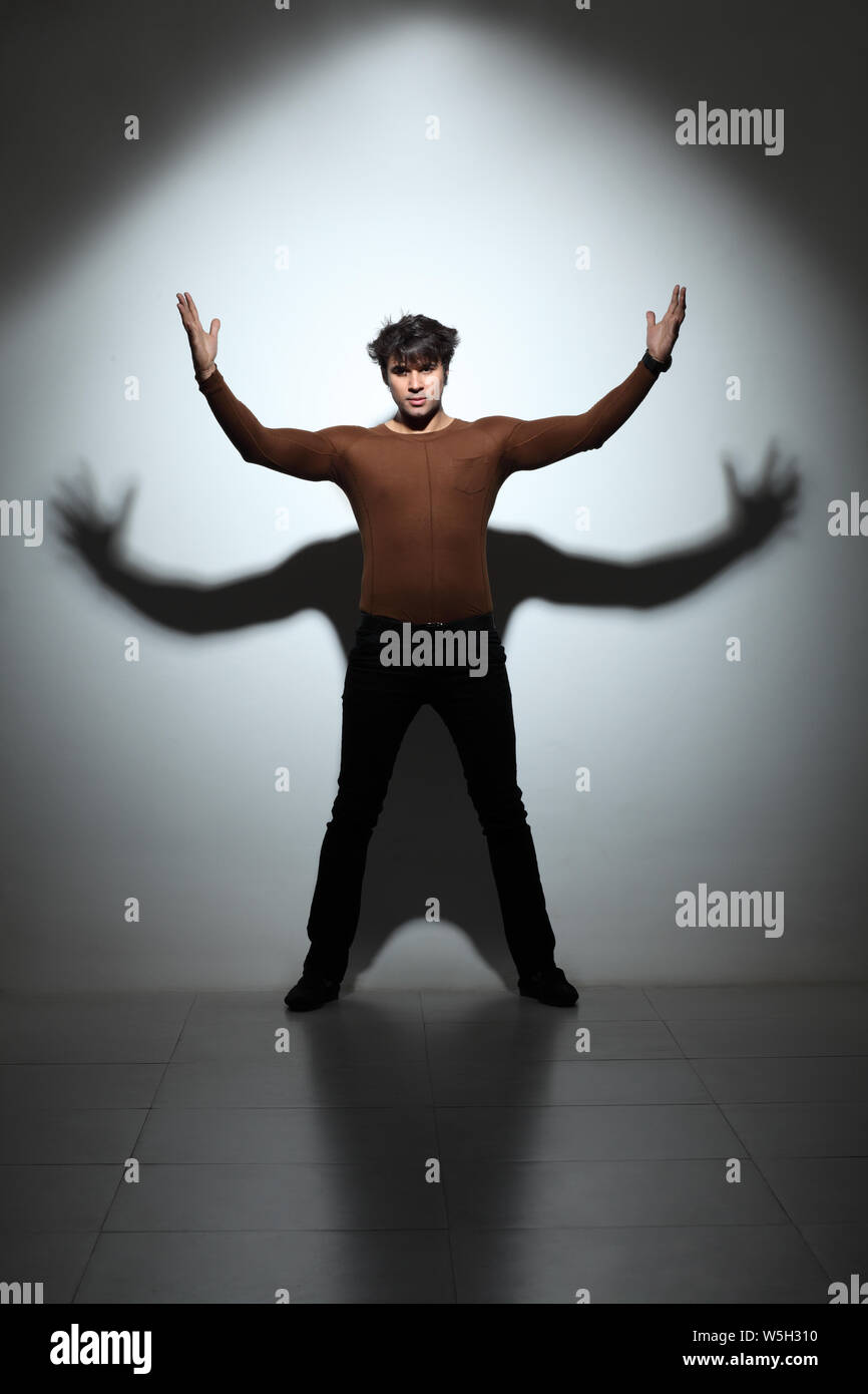 Shadow man one arm raised hi-res stock photography and images - Alamy