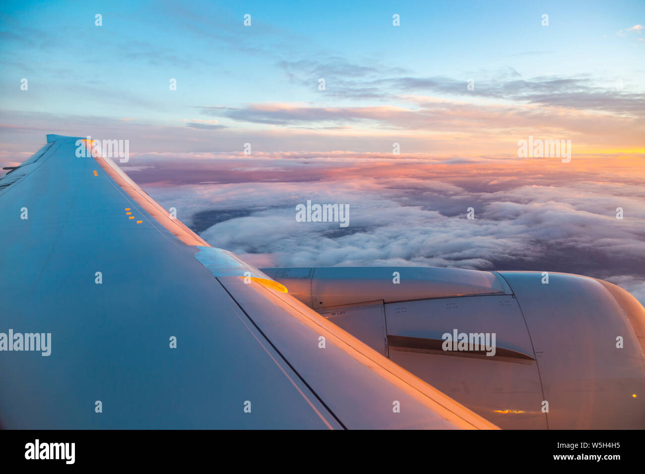 Generic view from airplane window of airplane wing and sunrise over ...
