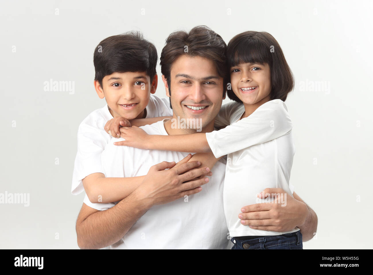 Father with two children smiling Stock Photo - Alamy