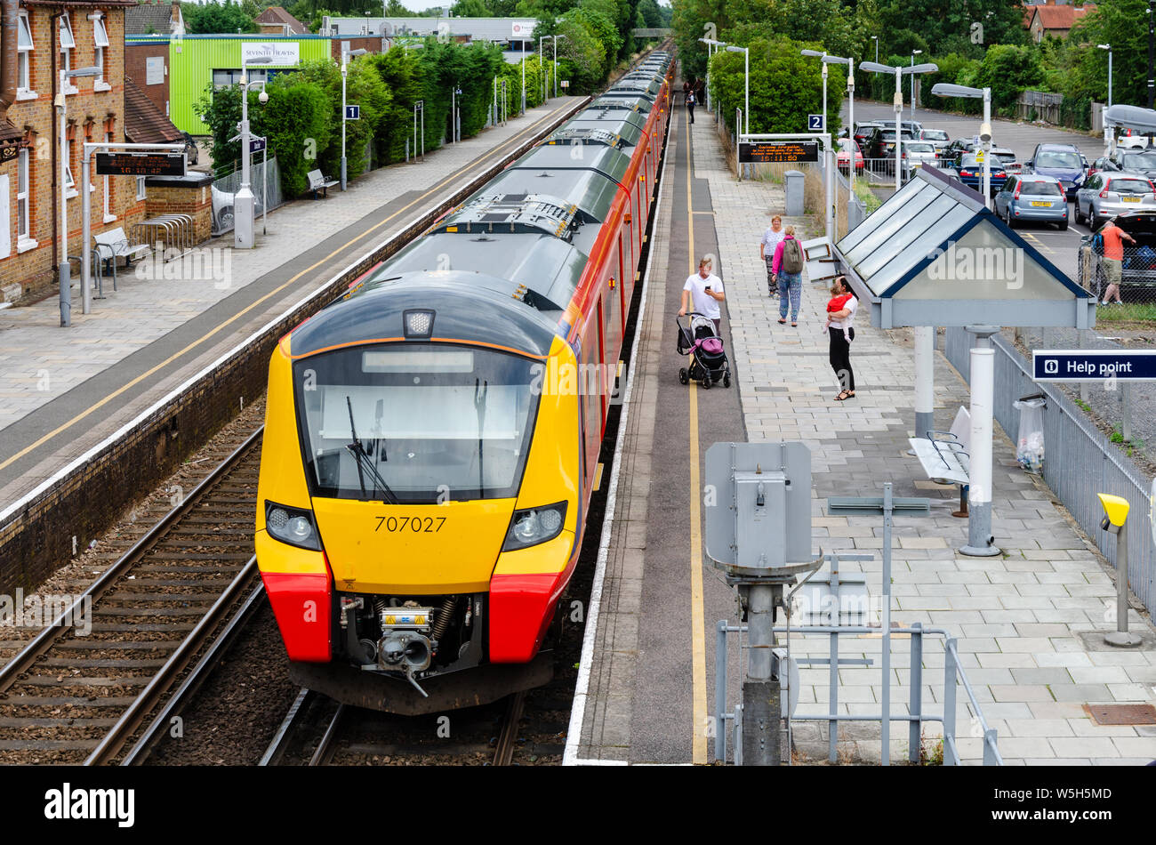 A train sits in Datchet Railway Station where a handful of passengers ...