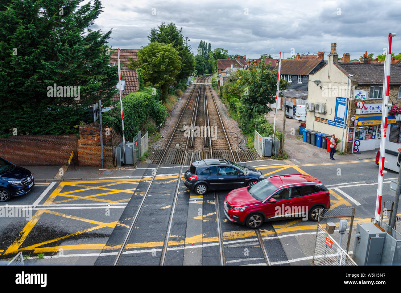 Cars pass through a level crossing outside Datchet Railway Station ...