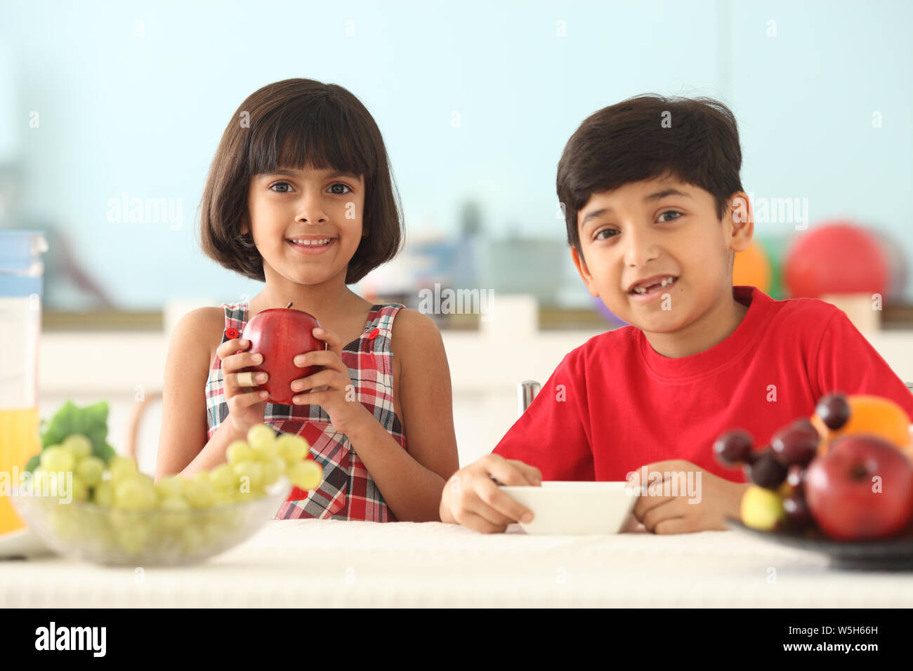 Two children having breakfast Stock Photo - Alamy