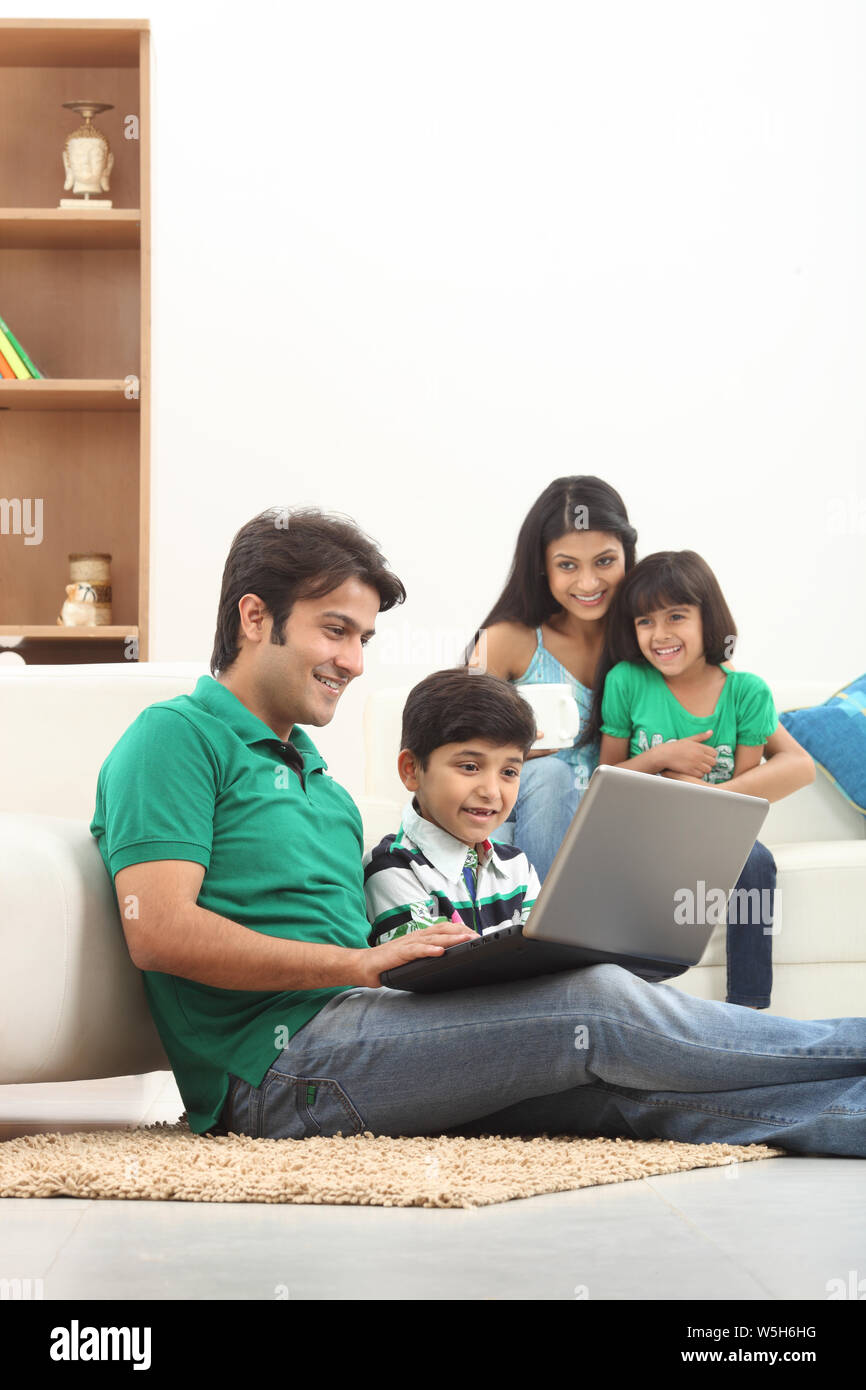 Man with his son working on a laptop Stock Photo - Alamy