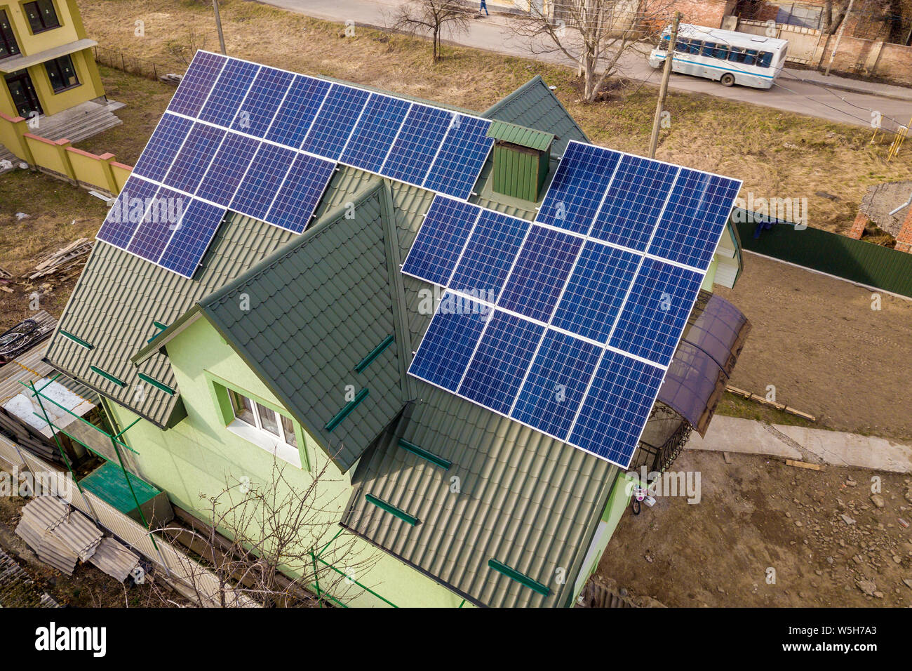 Aerial view of house cottage with blue shiny solar photo voltaic panels ...