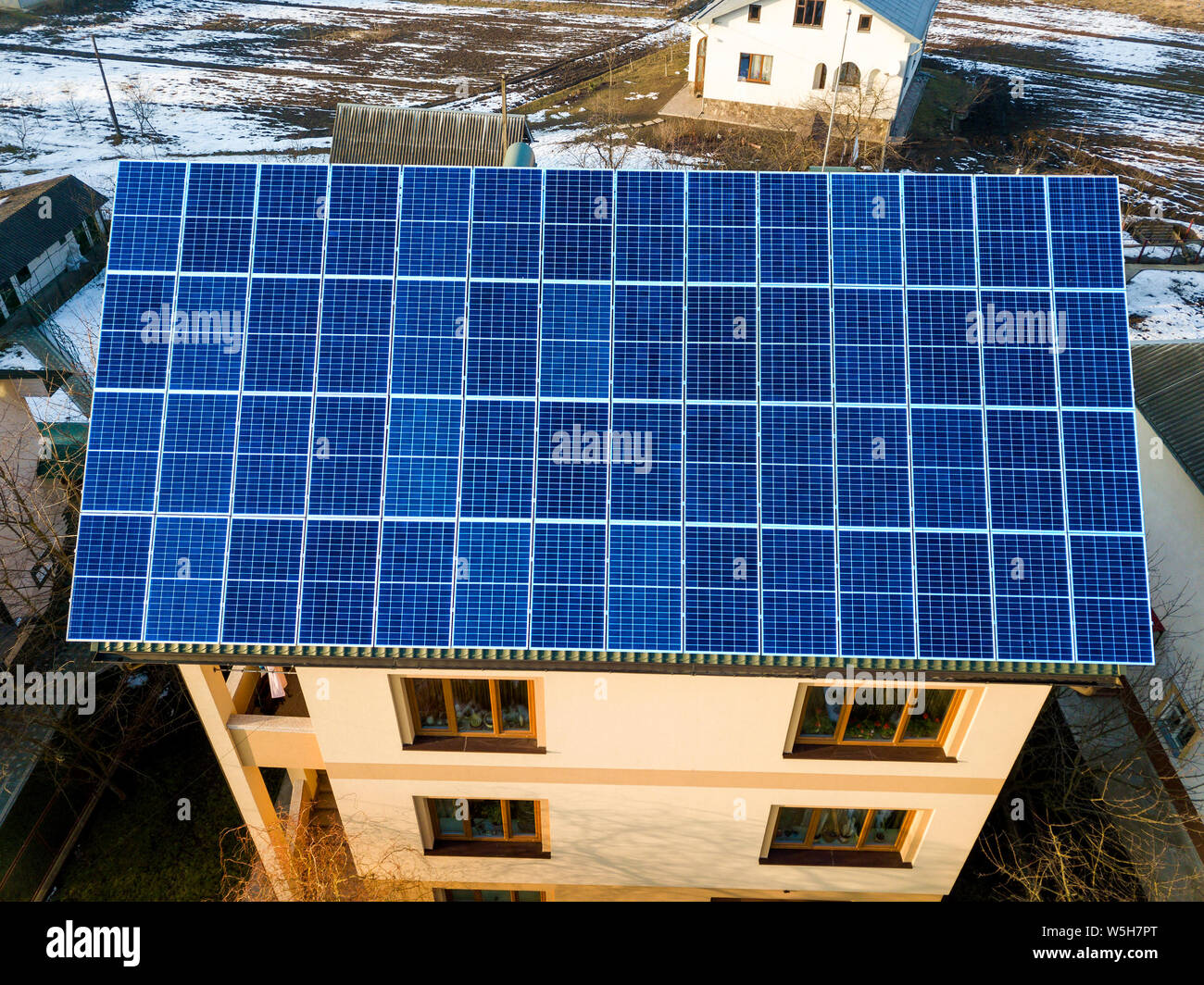 Aerial view of new modern two story house cottage with blue shiny solar ...