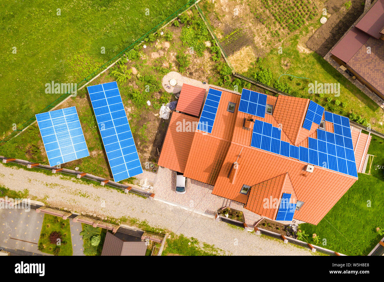 Aerial top view of new modern residential house cottage with blue shiny ...