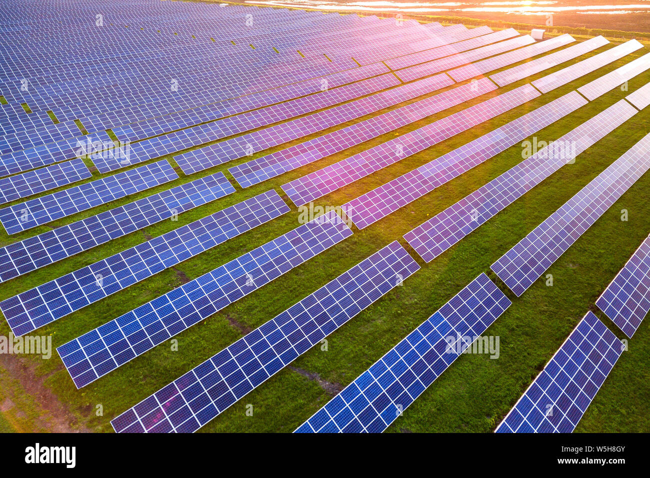 Blue solar photo voltaic panels system producing renewable clean energy on rural landscape and ...