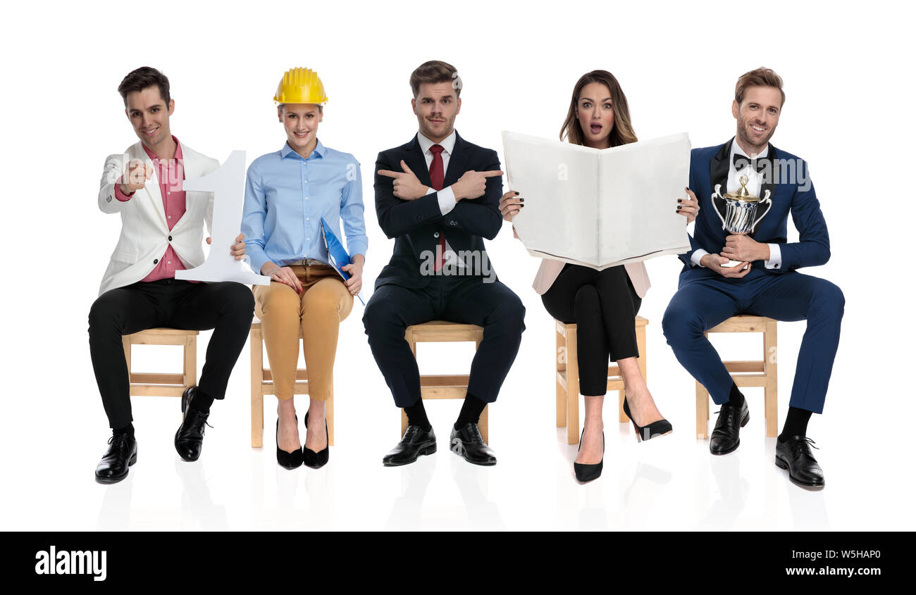 different young people sitting on chairs and each doing something else ...