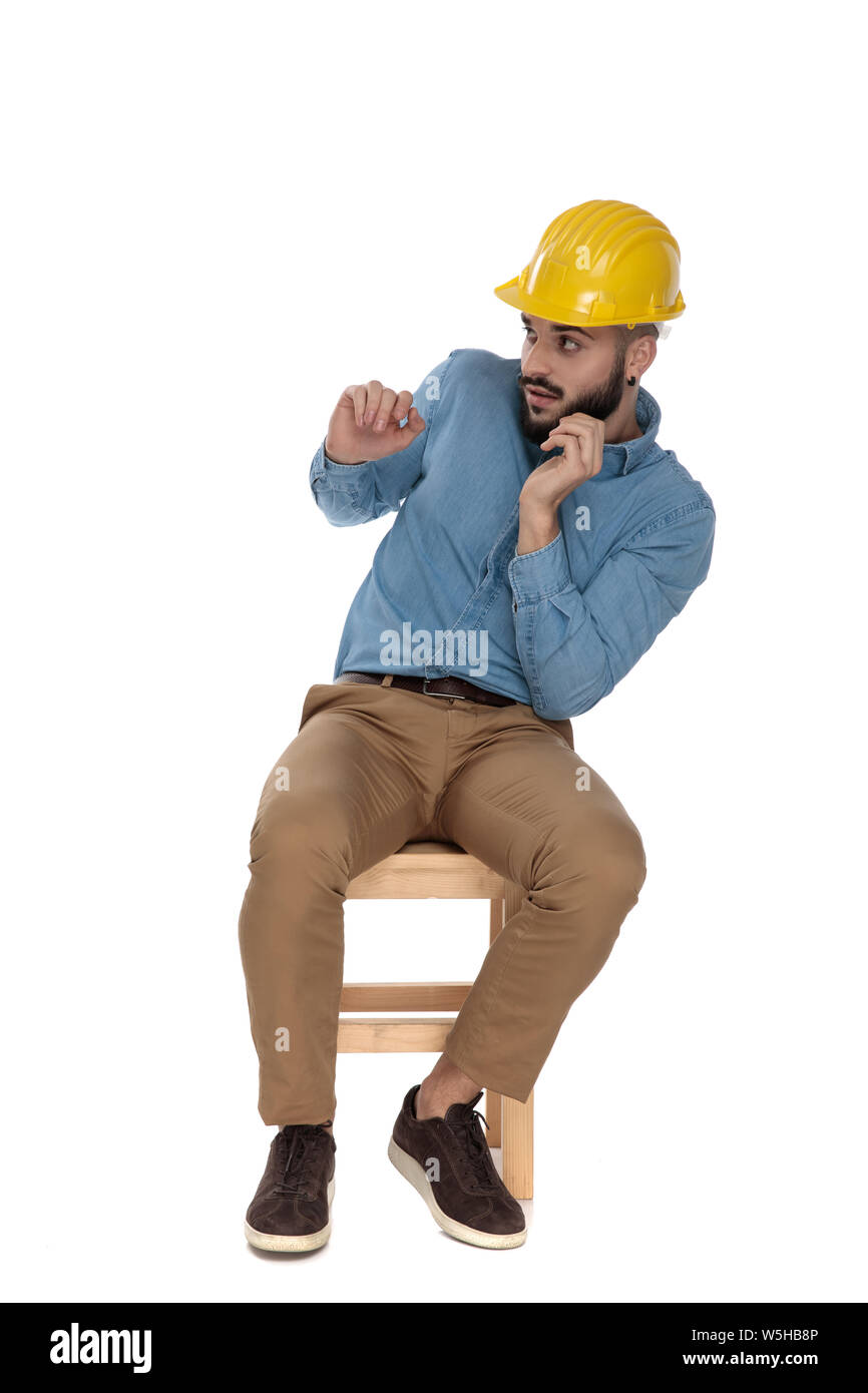 scared engineer student in blue jeans shirt sitting and looking away ...