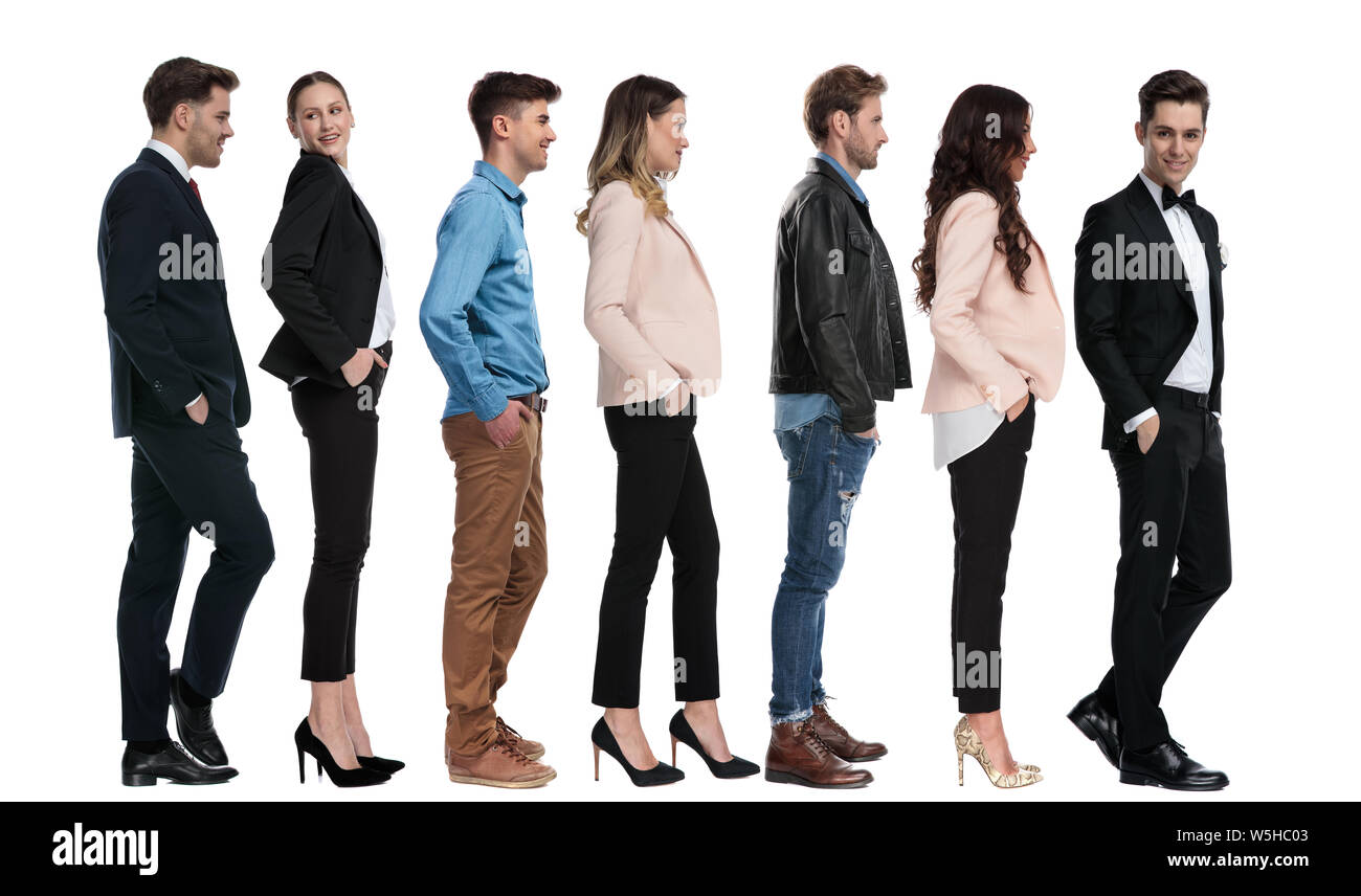 elegant leader looks at the camera while standing first in line with ...