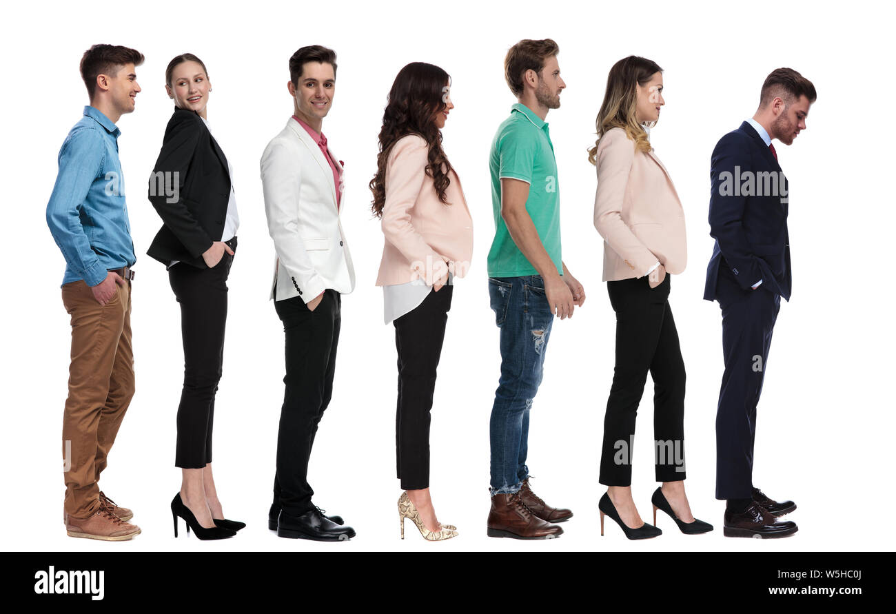 curious businessman looks down at something while witing in line with ...