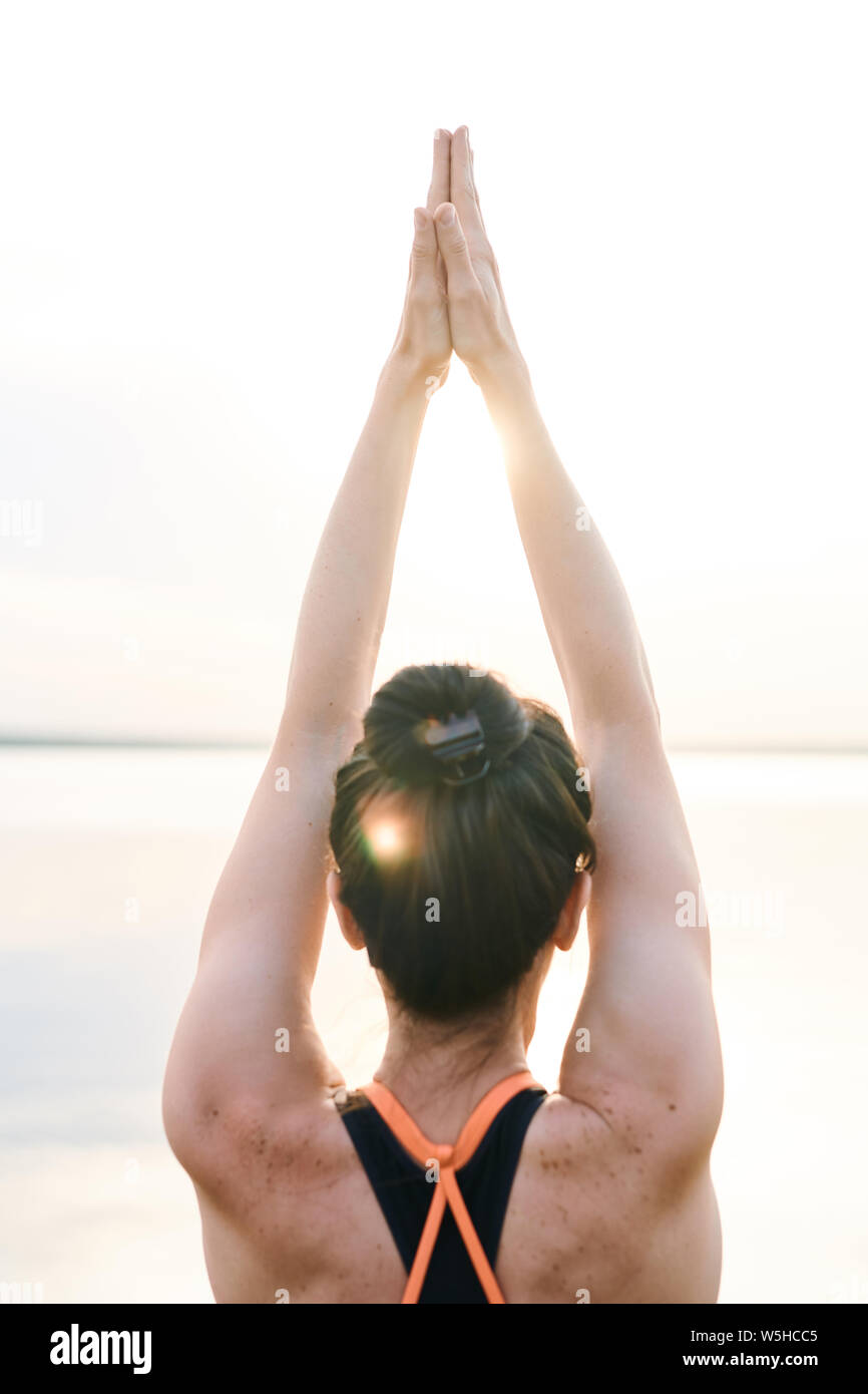 Aligning body with sun salutation exercise Stock Photo - Alamy
