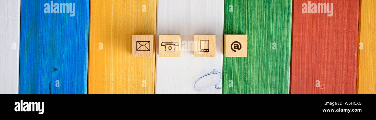 Wide view image of five wooden blocks with communication icons on them ...