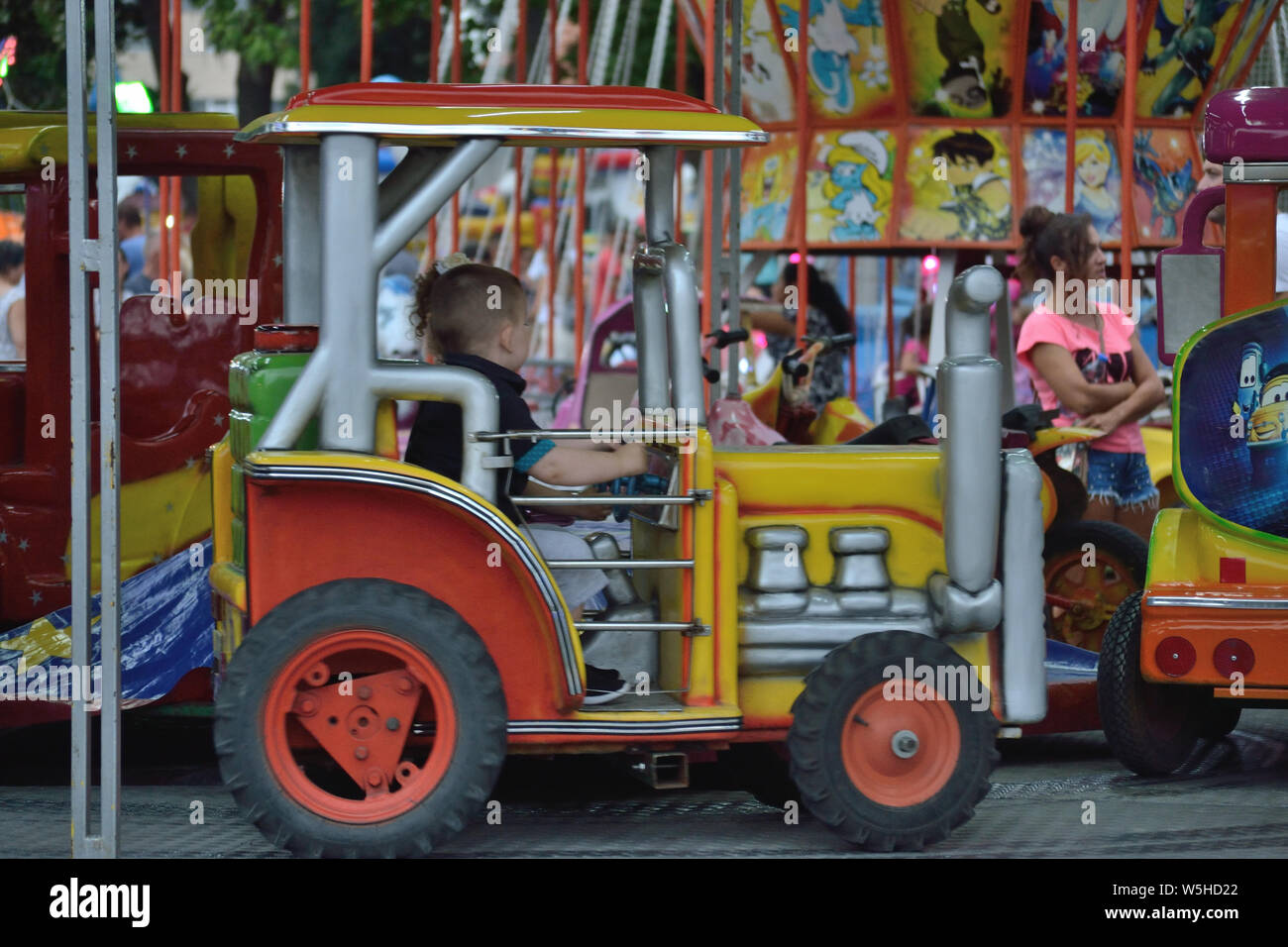 Kid on a kiddie ride, Svilajnac, Serbia, Europe Stock Photo - Alamy